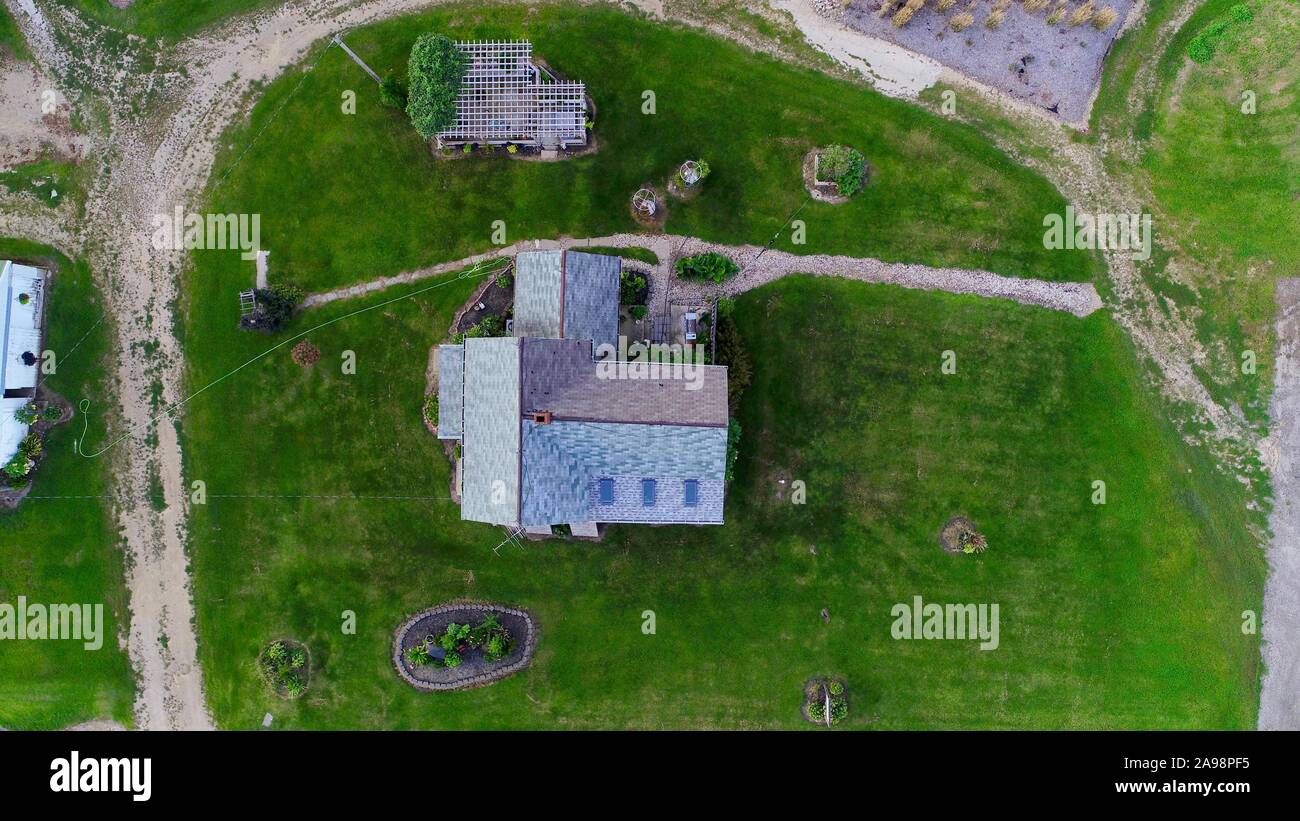 Aerial view of rural farmstead with rolling countryside at sunset with ...