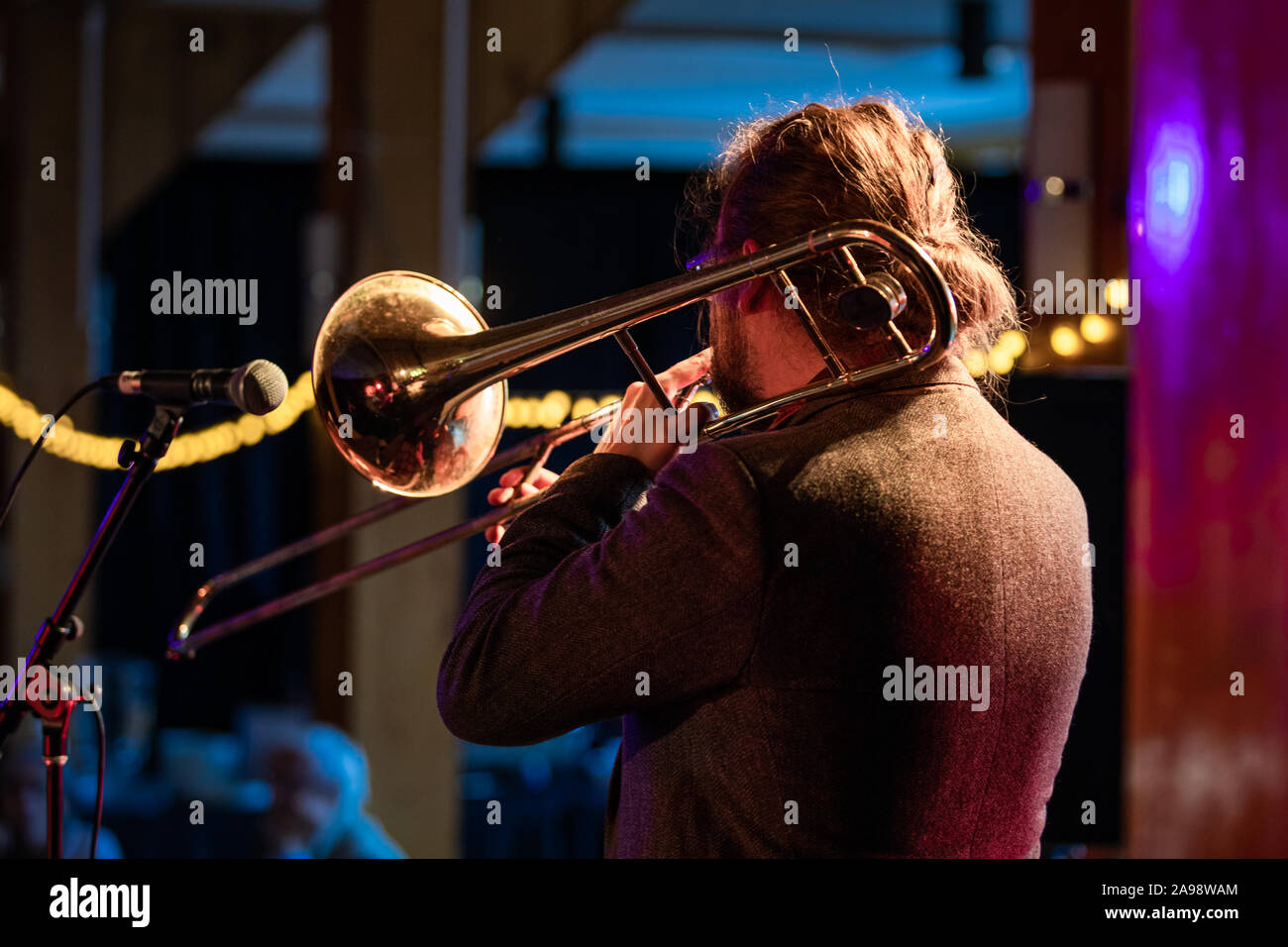 Backside view of an adult male giving a live performing on stage by ...