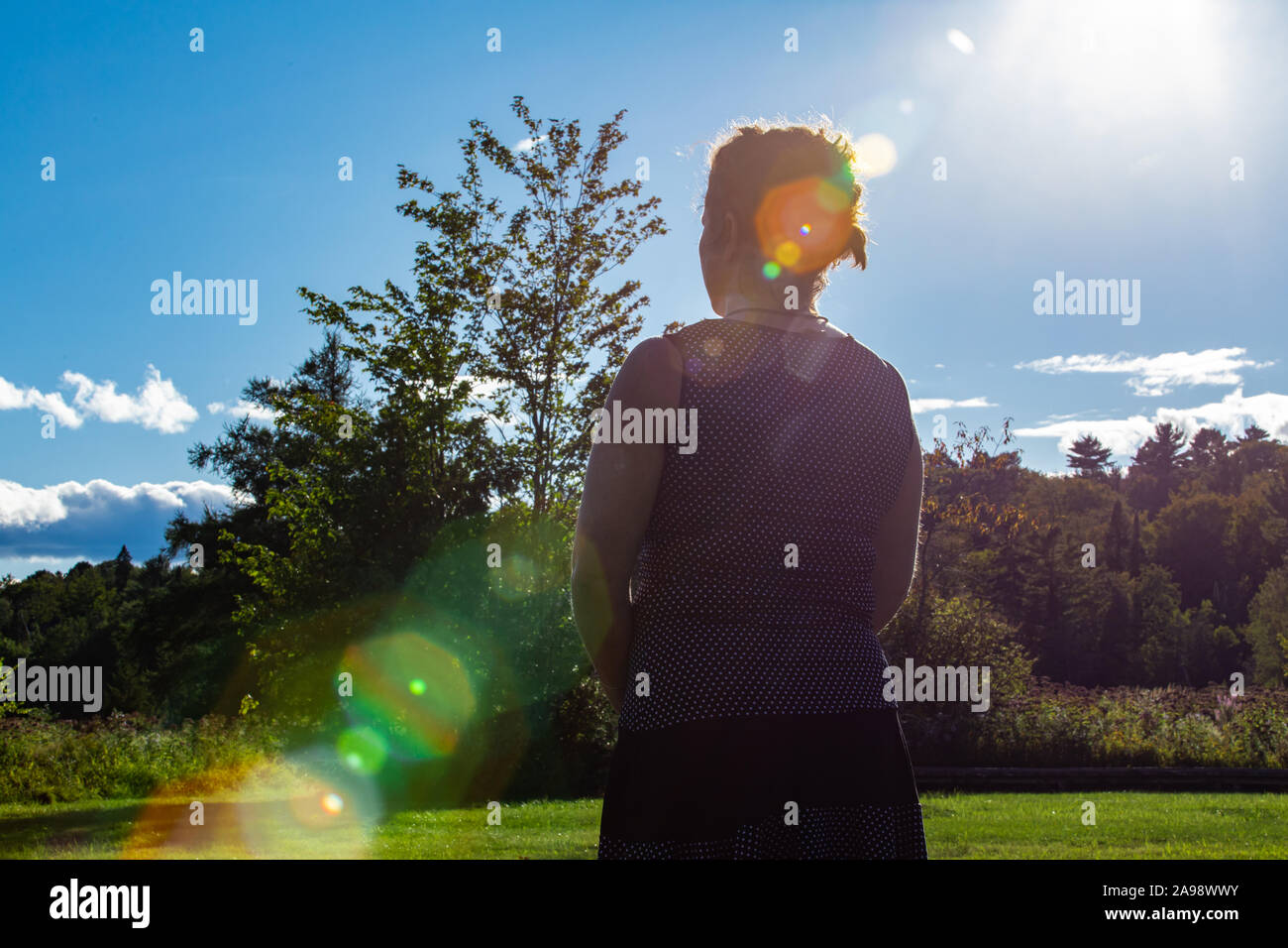 Backside view photo of young or middle aged woman standing alone ...