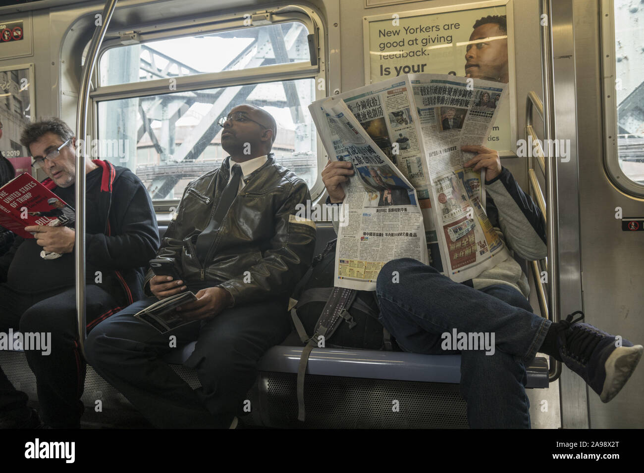 People reading as they ride a subway train in Brooklyn, New York Stock ...