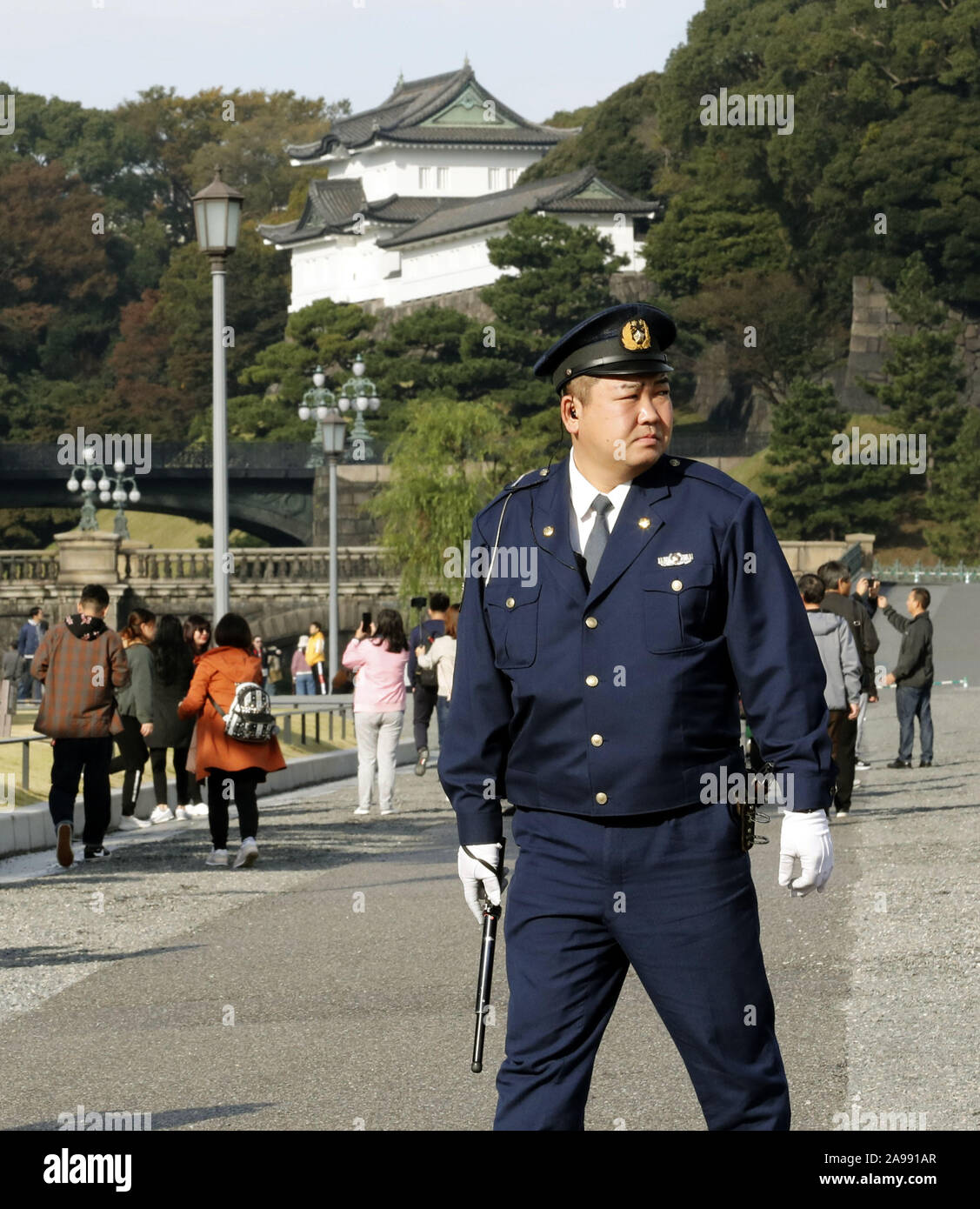 Tokyo, Japan. 14th Nov, 2019. A police officer patrols by the Imperial ...