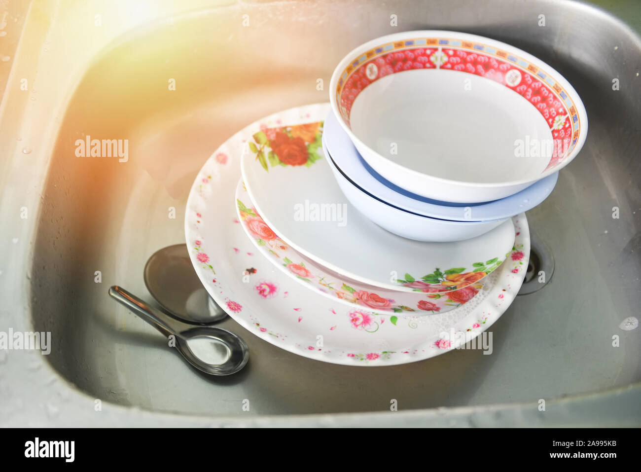 Plate in the sink kitchen for cleaners waiting washing dishes in home ...
