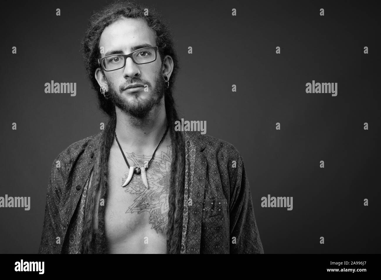 Young handsome Hispanic man with dreadlocks in black and white Stock ...