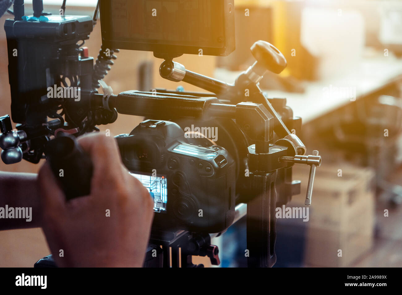 filming crew. cameraman shooting film scene with camera Stock Photo - Alamy