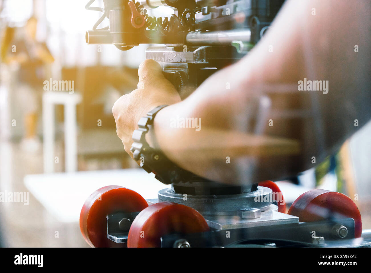 filming crew. cameraman shooting film scene with camera Stock Photo - Alamy