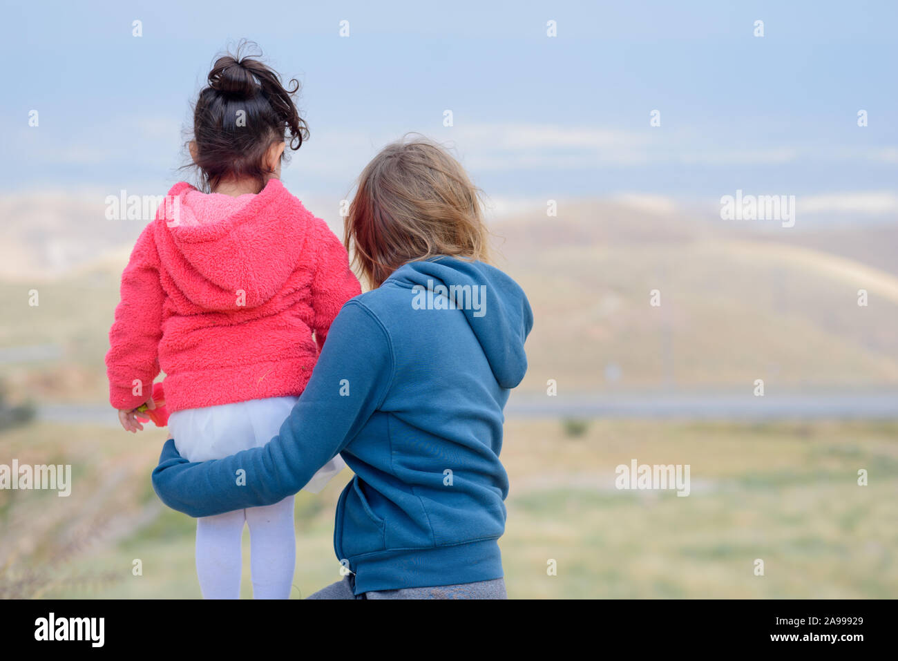 Young mother holding baby looking at amazing landscape.Family traveling ...