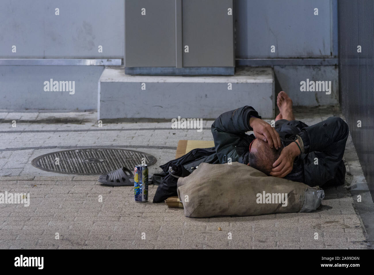A homeless man sleeping on the street in Shinjuku, Tokyo, Japan Stock ...