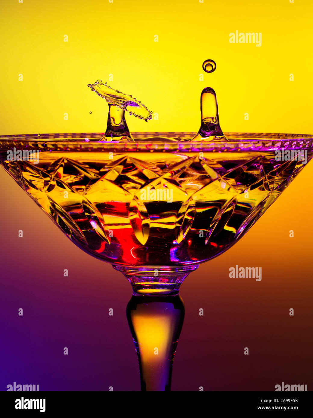 Two water drop collisions forming shapes in a champagne glass Stock ...