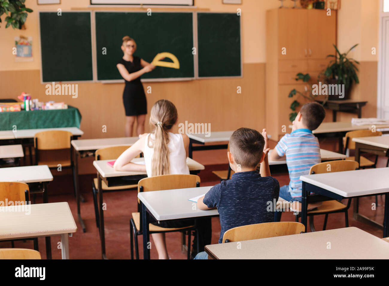 Back view of children sitting in the class room and study. Elementary ...