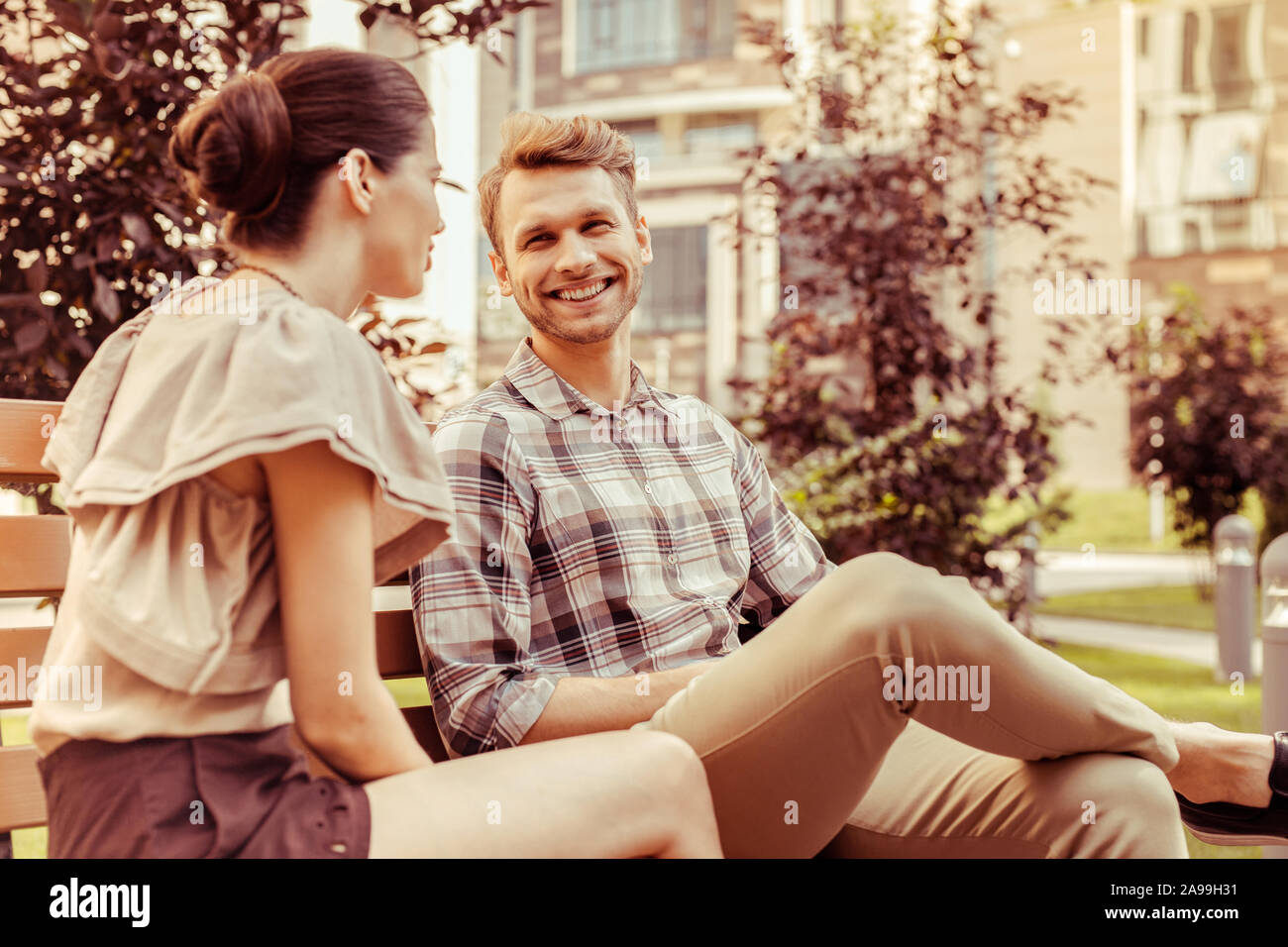 Positive delighted young people having pleasant conversation Stock ...
