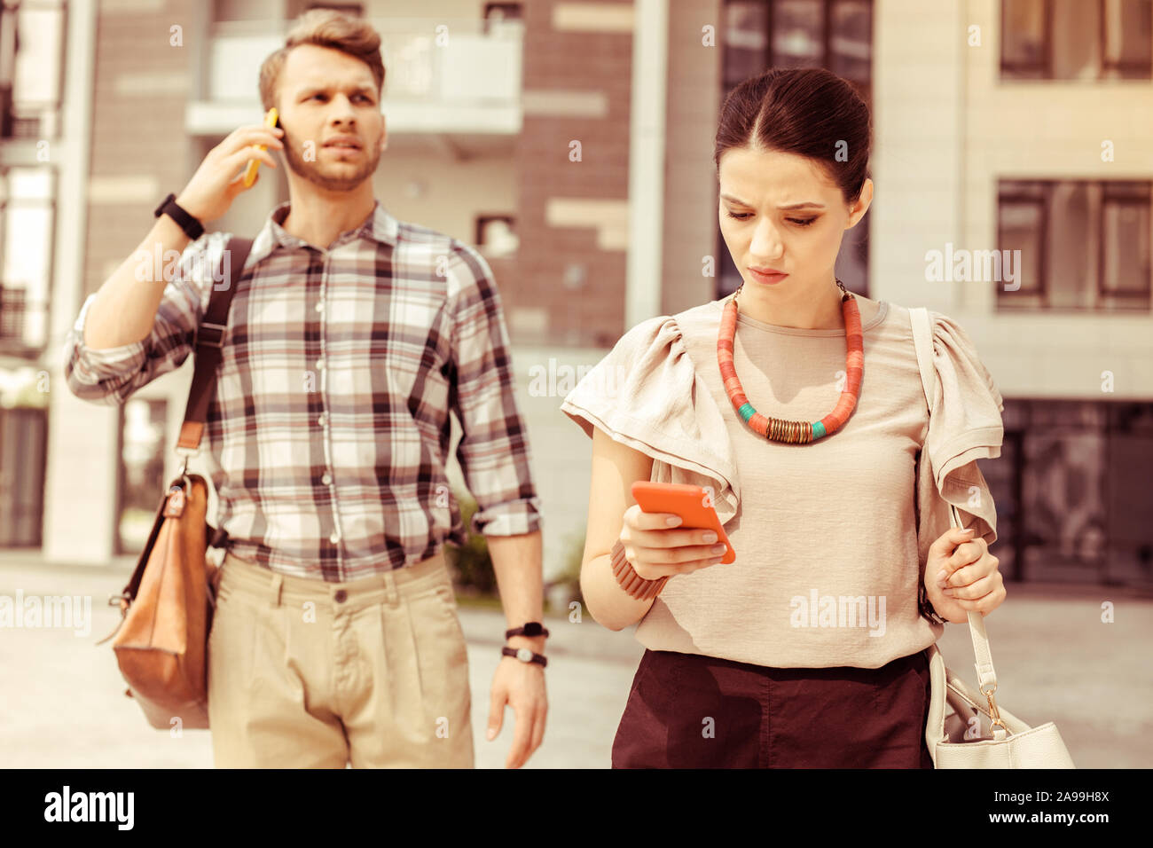 Concentrated young female person staring at telephone Stock Photo - Alamy