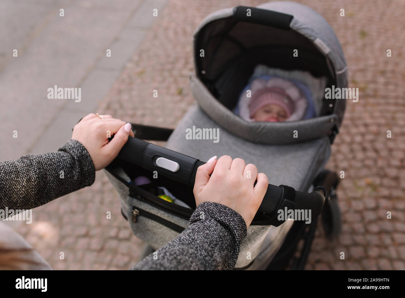 First person view of mother strolling with newborn outside. Mother's ...