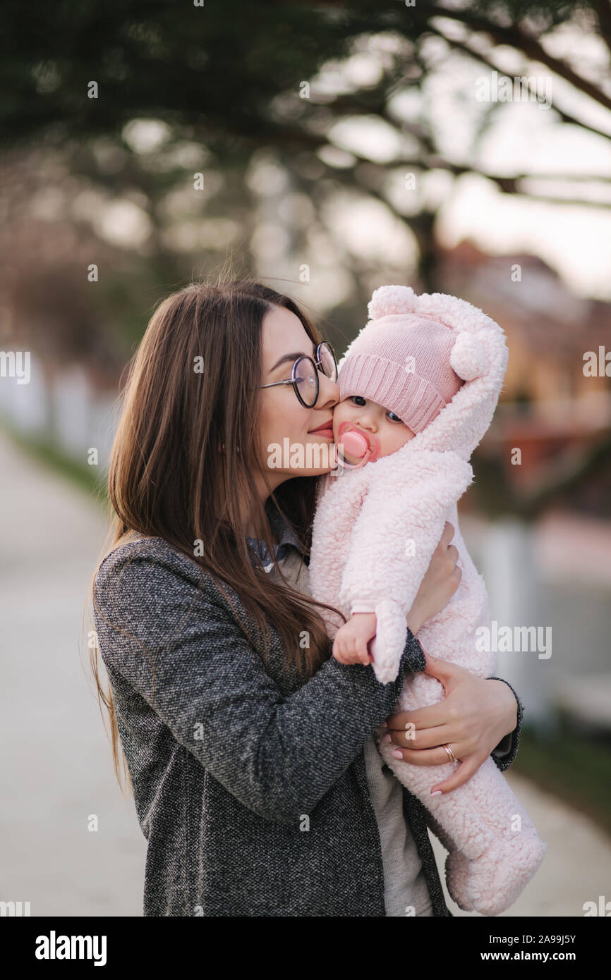 Young mother with her little baby. Mom hold baby on hands. Happy family ...