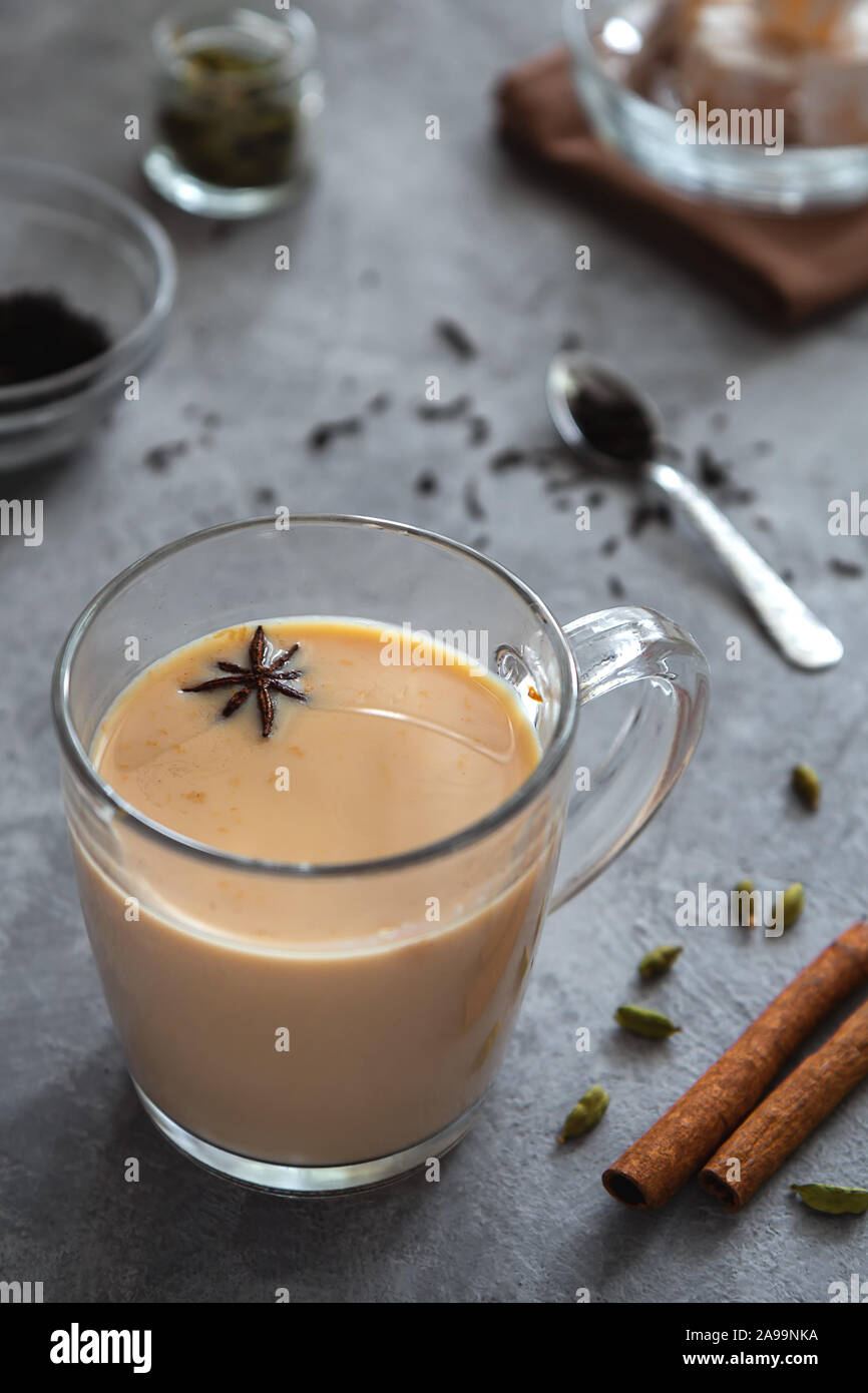 Traditional Indian warming drink Masala tea with spices and milk in a ...