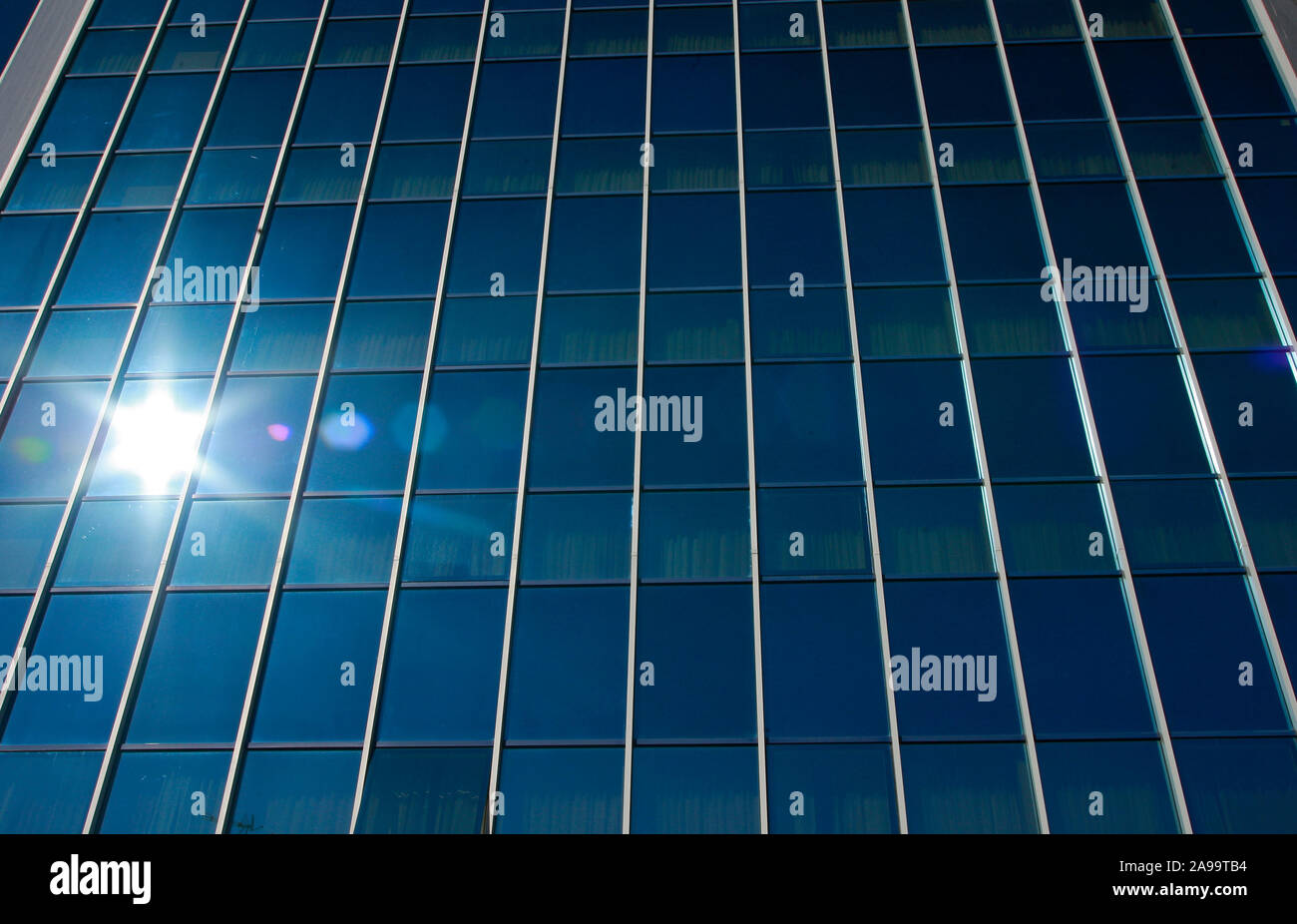 sun rays reflecting on glass facade of building Stock Photo - Alamy