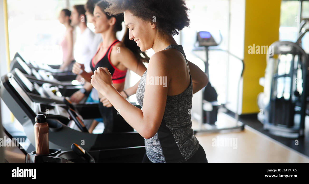Group of people exercising in a gym cardio training and running Stock ...