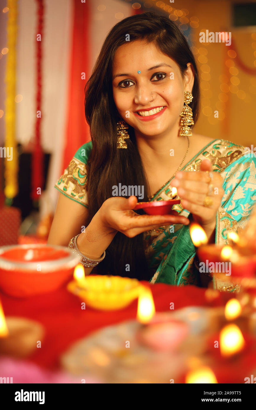 Woman holding diya hi-res stock photography and images - Alamy