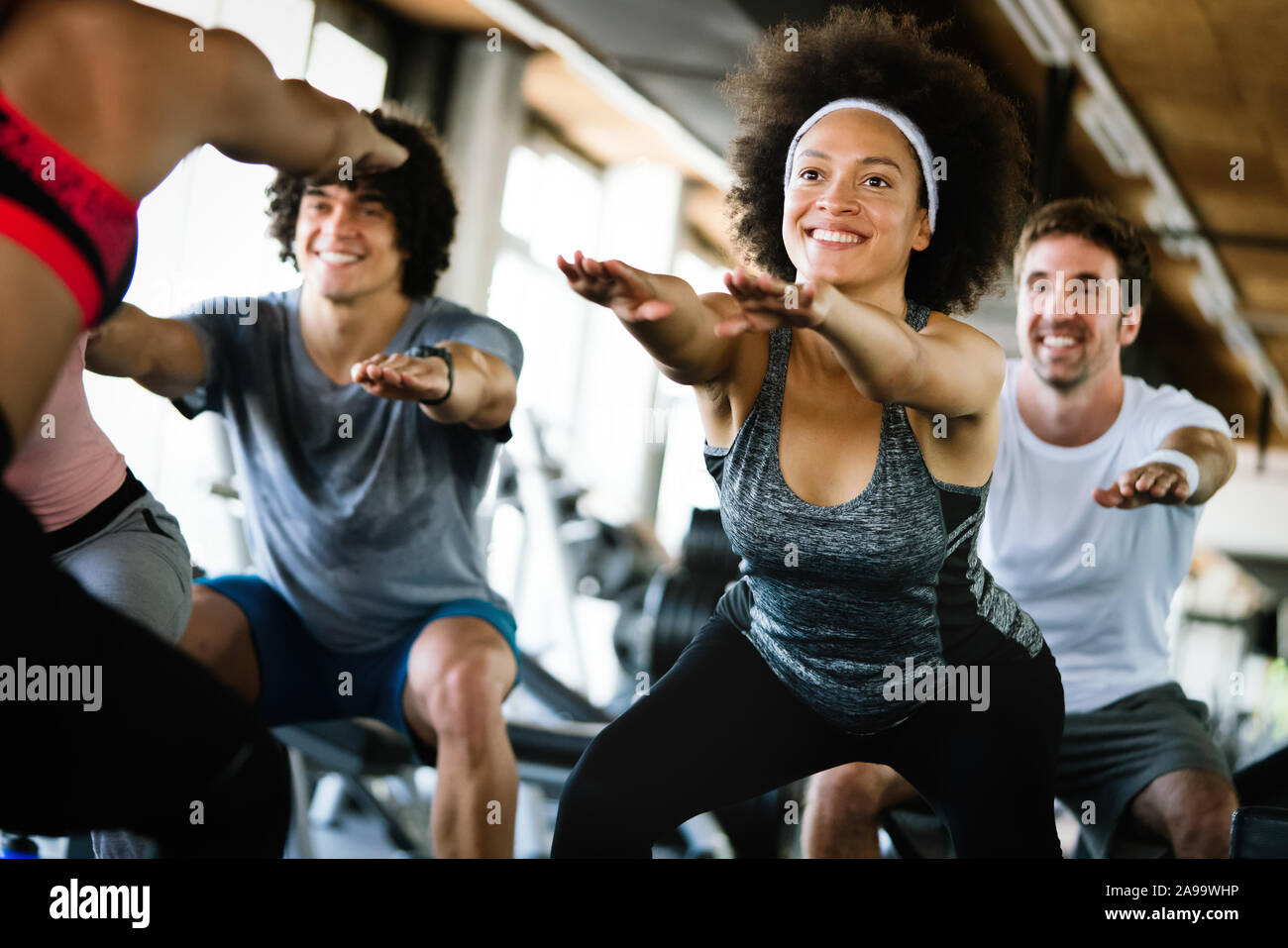 Beautiful fit people exercising together in gym Stock Photo - Alamy