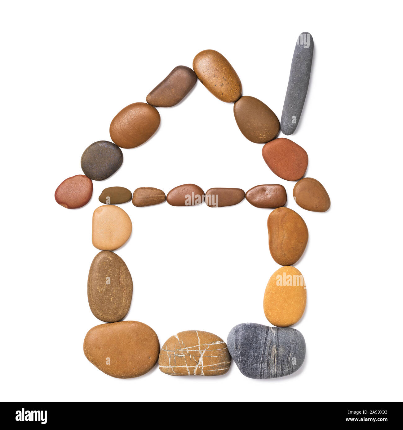 The shape of the house is laid out of sea pebbles isolated on a white ...
