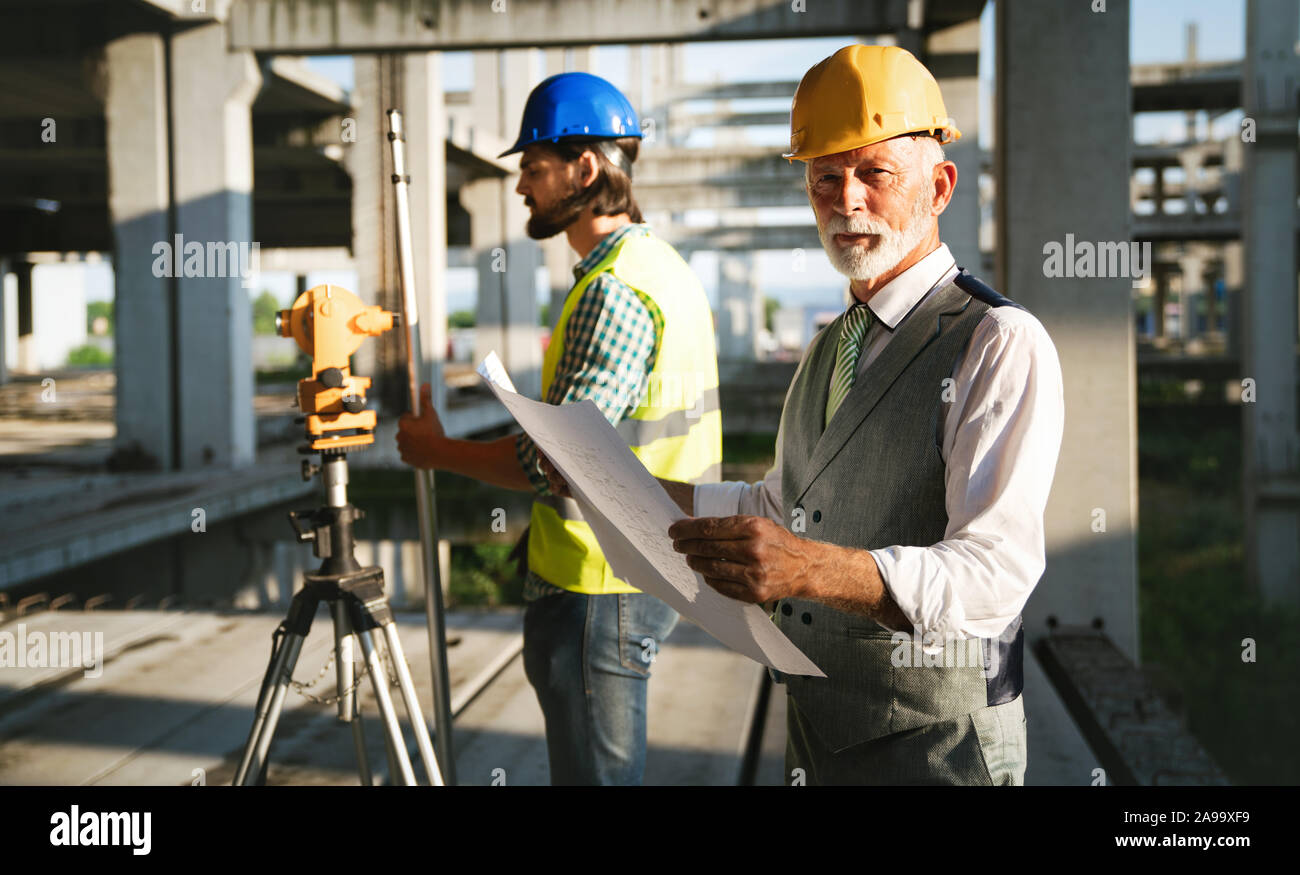 Architect and construction engineer or surveyor discussion plans and ...