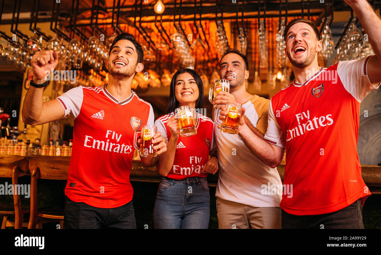 Party excited arsenal fans watching soccer with Ganzberg Beer in the ...