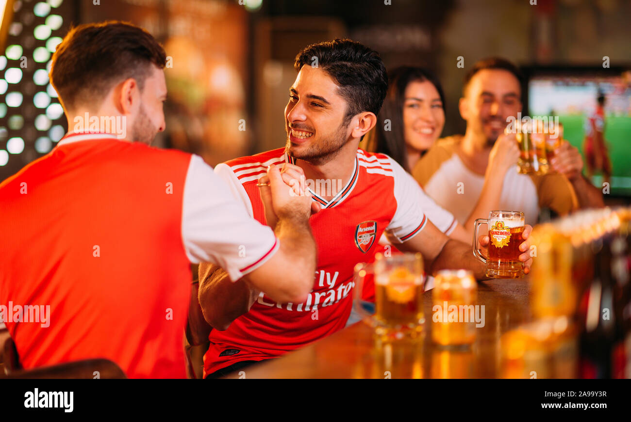 Party excited arsenal fans watching soccer with Ganzberg Beer in the ...