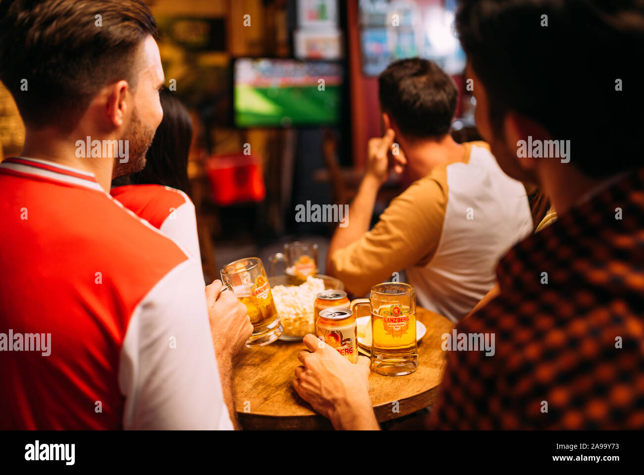 Party excited arsenal fans watching soccer with Ganzberg Beer in the ...