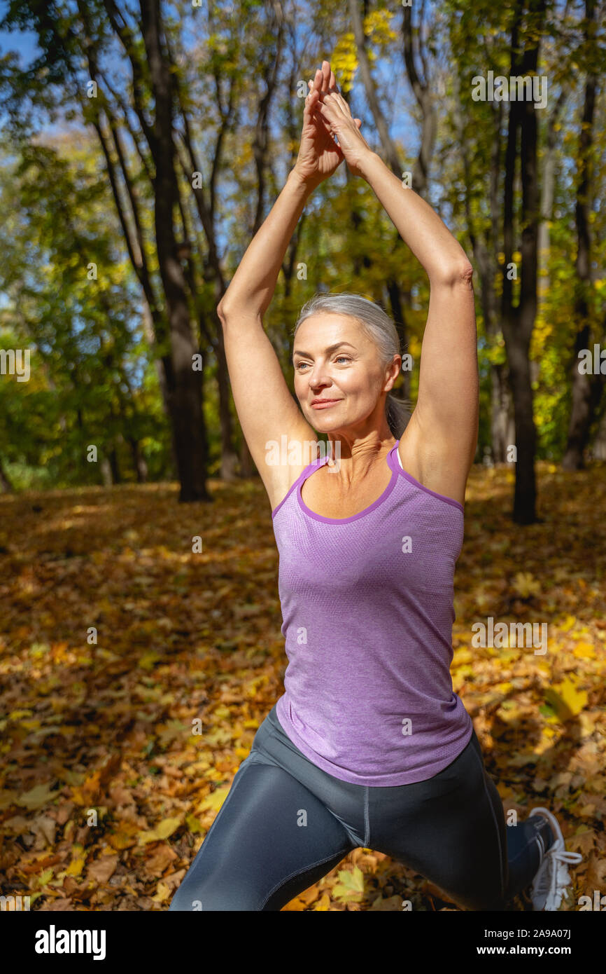 Female yogi performing a crescent lunge asana Stock Photo - Alamy