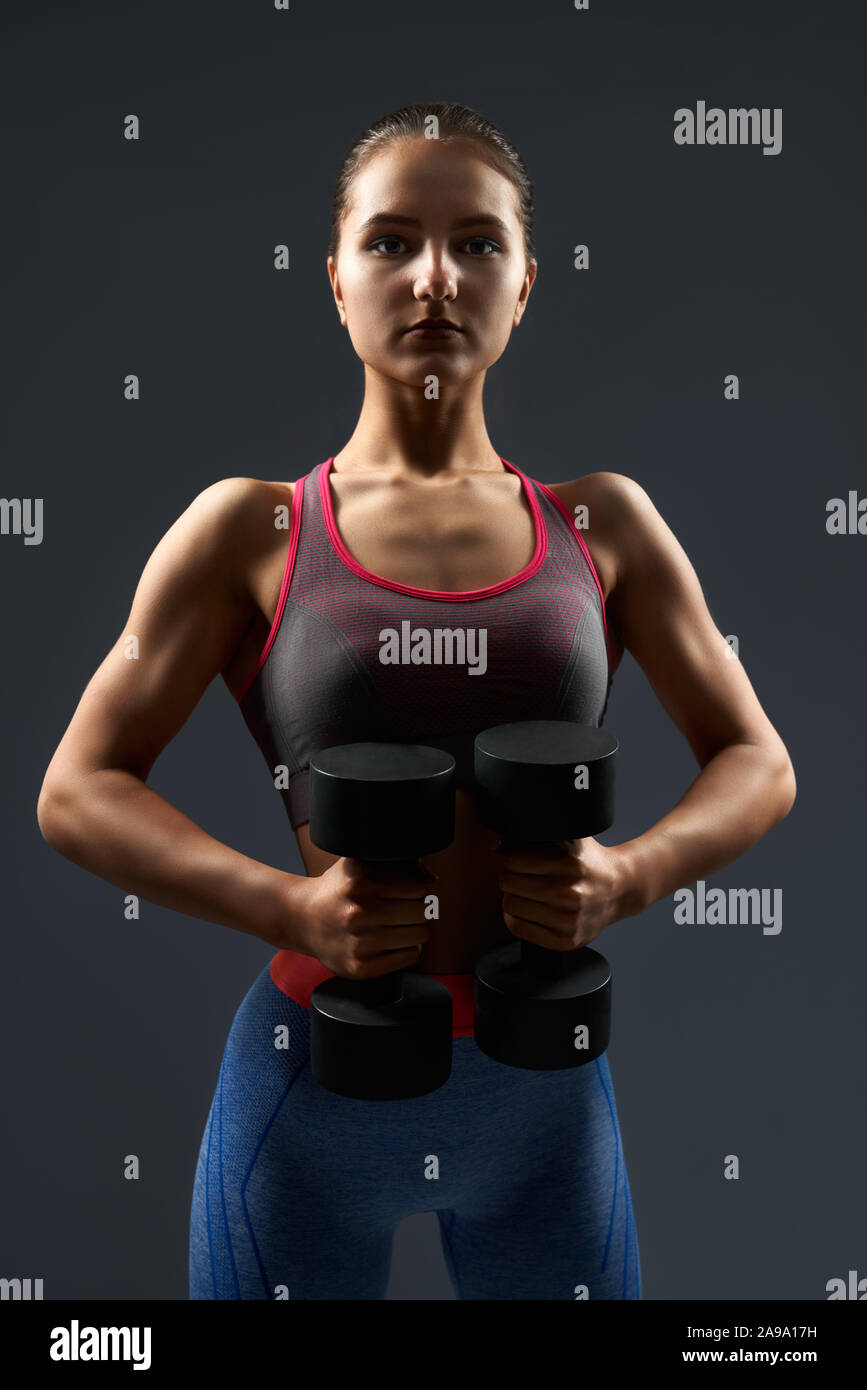Portrait of sports woman with gorgeous strong body and tanned skin ...