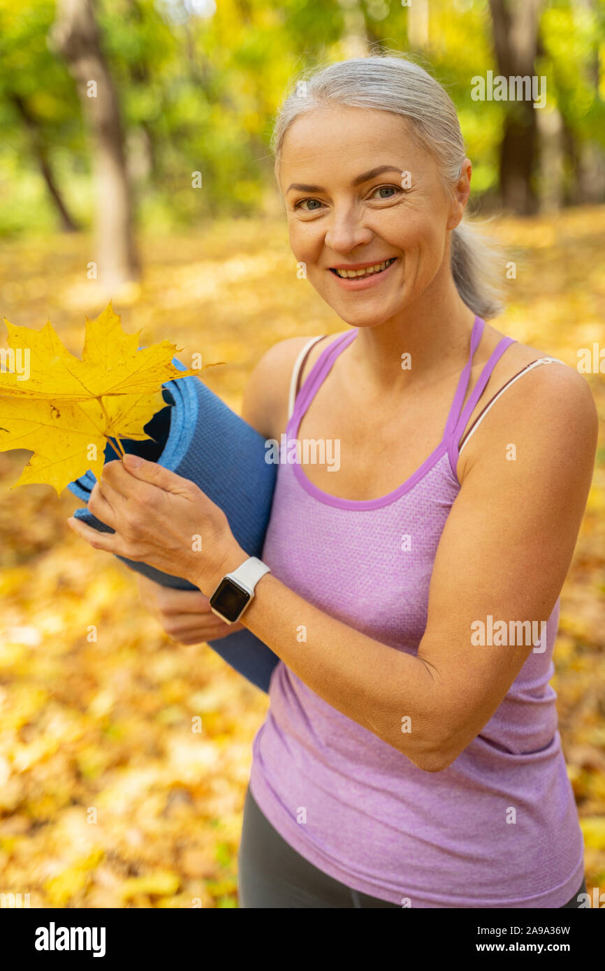 Pretty female yogi smiling at the camera Stock Photo - Alamy