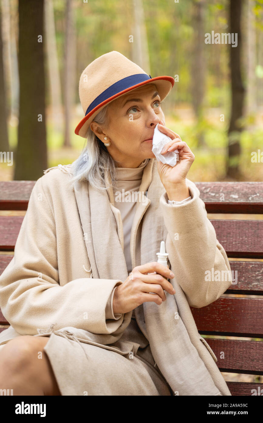Dispirited woman with a paper tissue looking up Stock Photo - Alamy