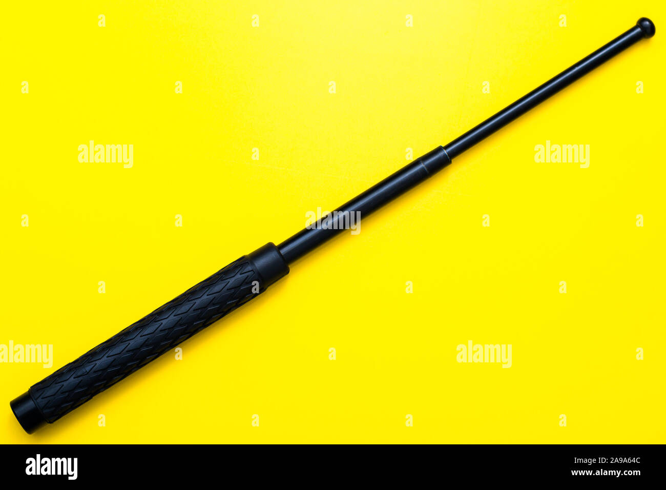 Black telescopic expandable baton / truncheon isolated Stock Photo - Alamy