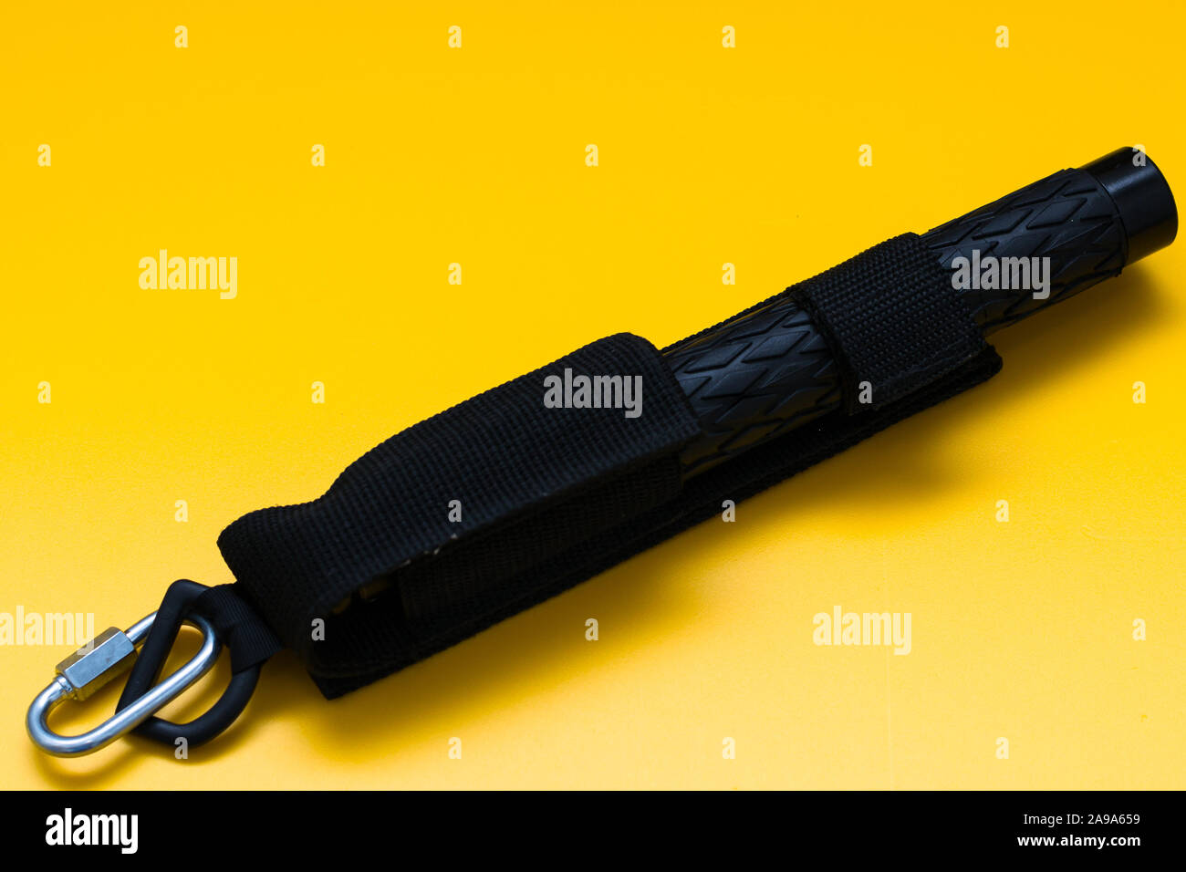 Black telescopic expandable baton / truncheon isolated Stock Photo - Alamy