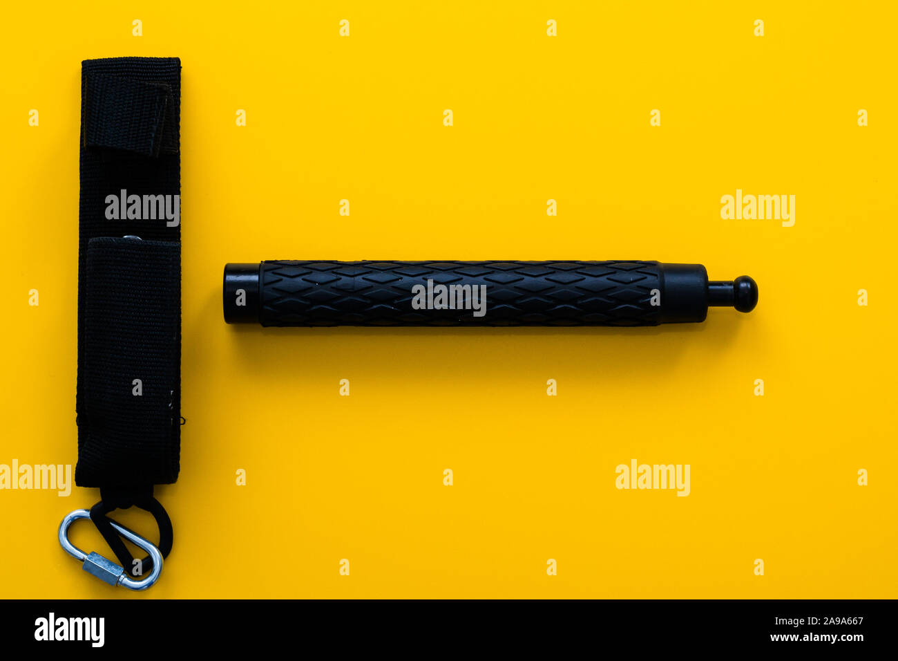 Black telescopic expandable baton / truncheon isolated Stock Photo - Alamy