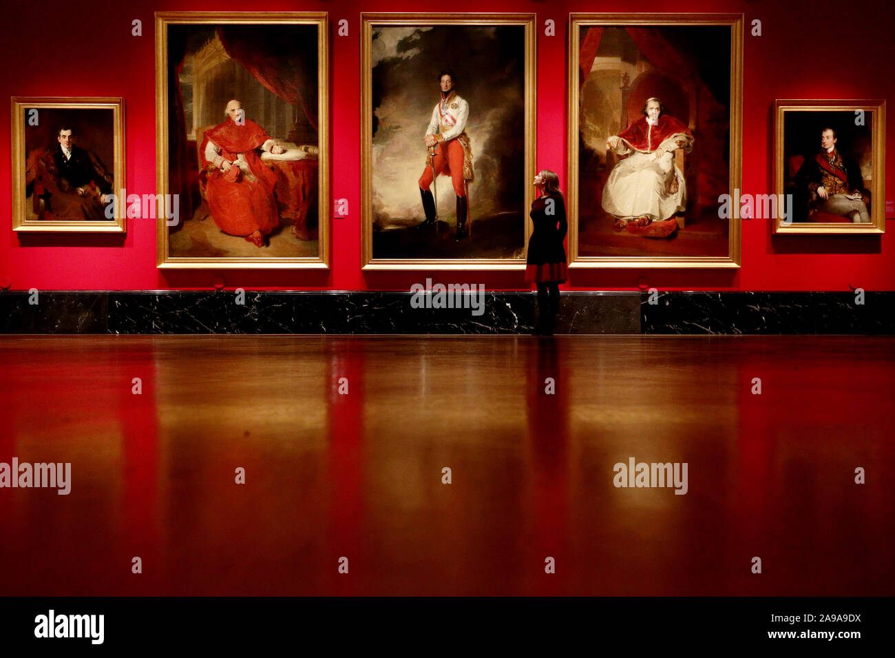 A Royal Collection staff member stands amongst the Waterloo Chamber ...