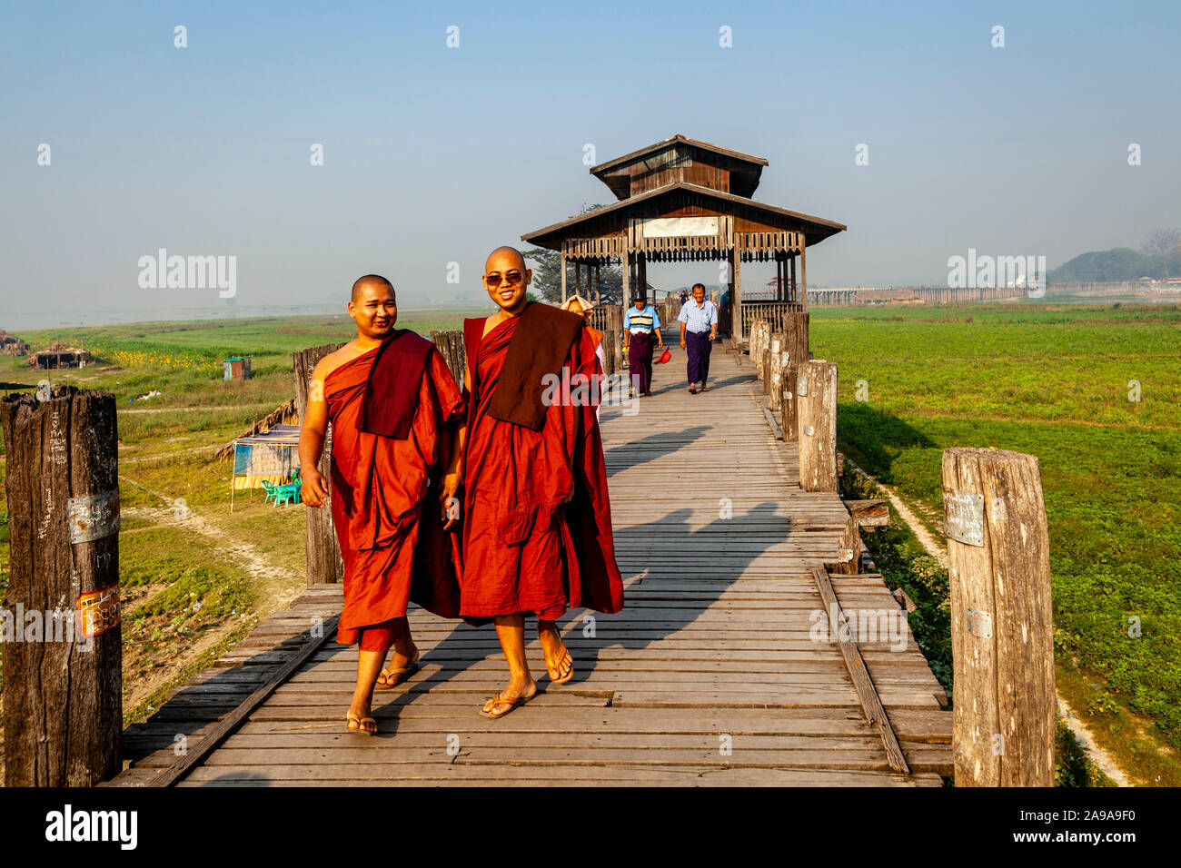Two Smiling Buddhist Monks Crossing U Bein Bridge, Amarapura, Mandalay ...