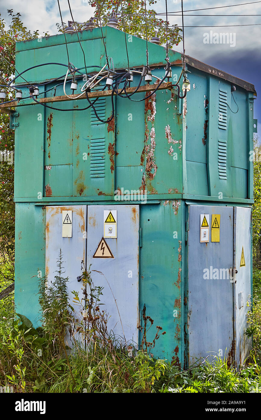 The construction of a rural transformer substation with warning signs ...