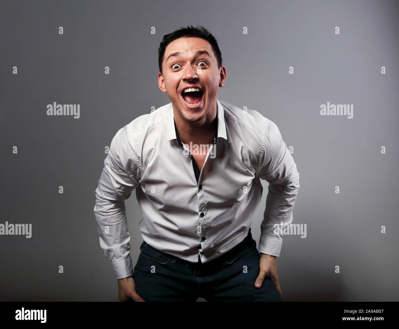 Excited crazy business man shouting loud with wide opened mouth and mad ...