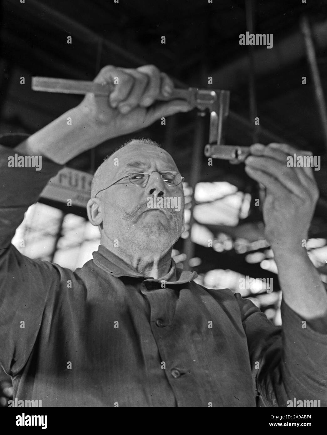 Worker at a factory hall at Mercedes Benz in Stuttgart, Germany 1930s ...