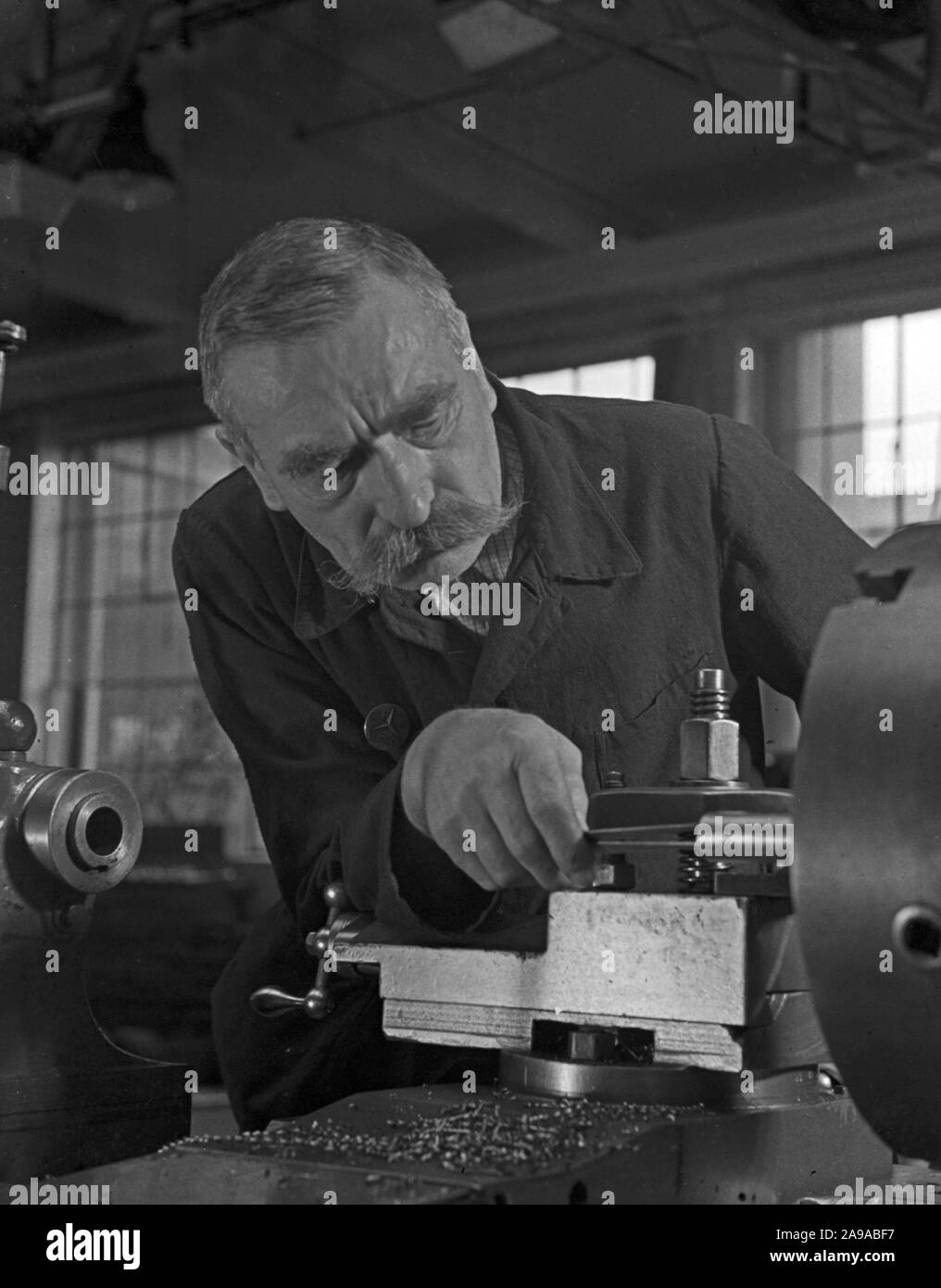 Worker at a factory hall at Mercedes Benz in Stuttgart, Germany 1930s ...