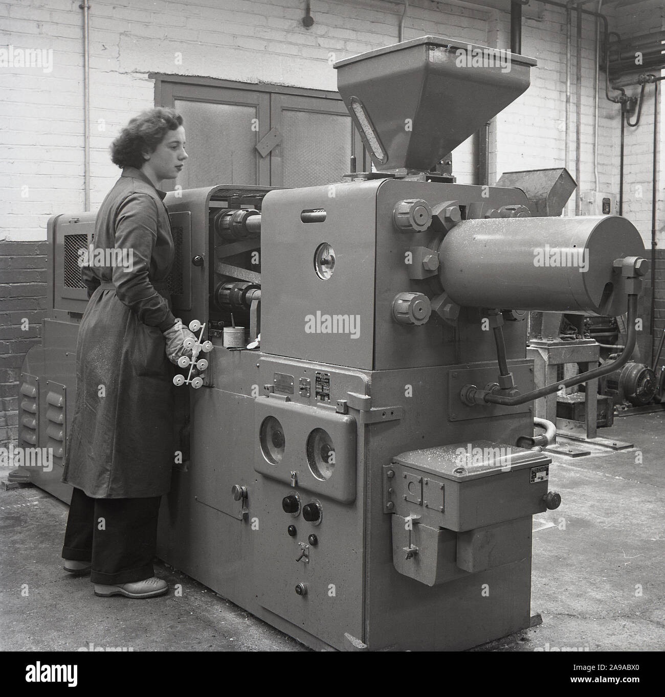1950s, historical, female worker in the Ever Ready battery factory ...