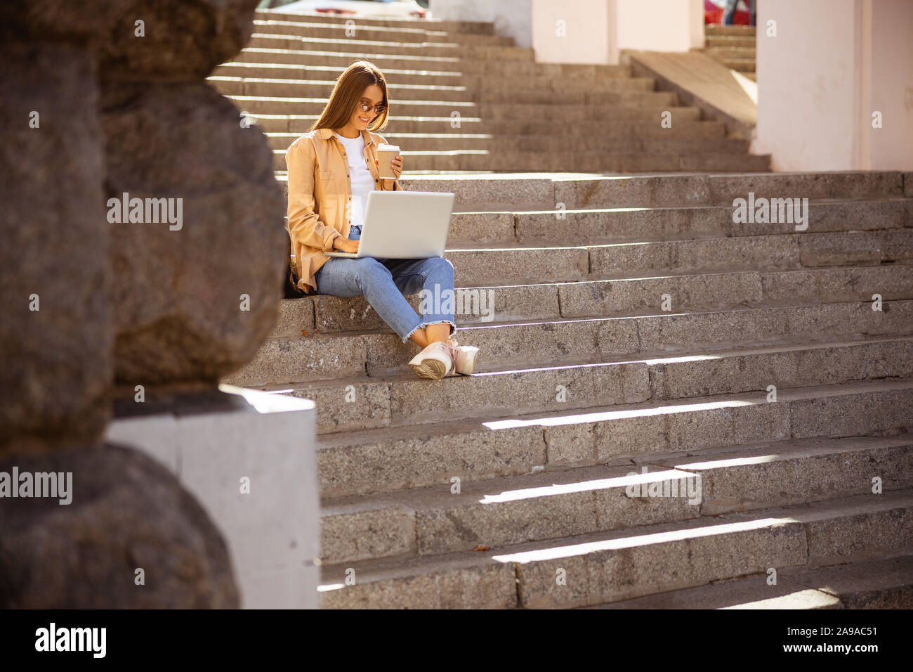 Beautiful woman laughing reading her new e-mail Stock Photo - Alamy