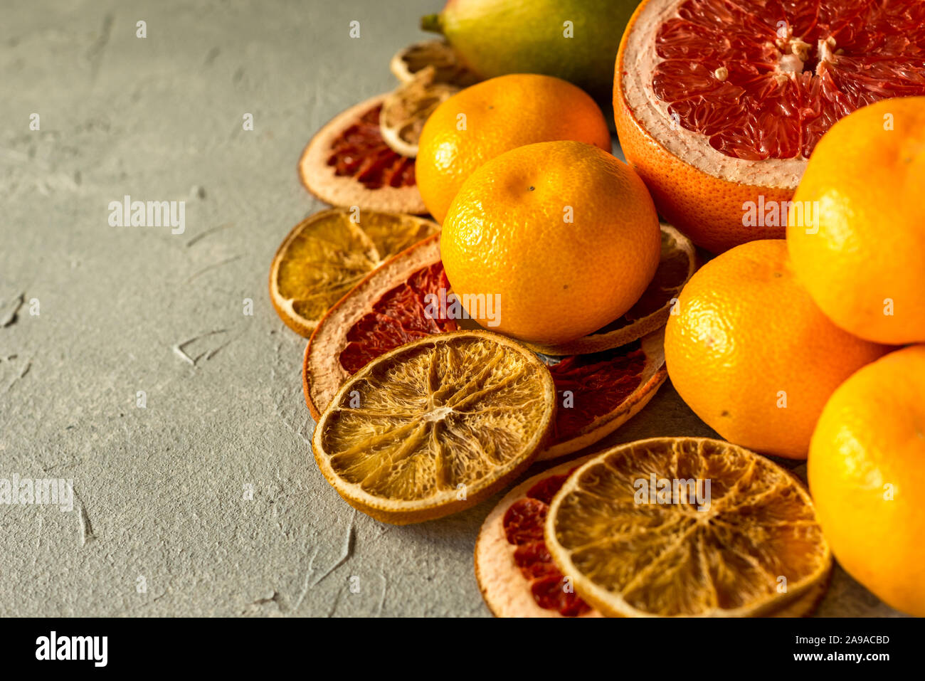 slices of citrus on gray texture background Stock Photo - Alamy