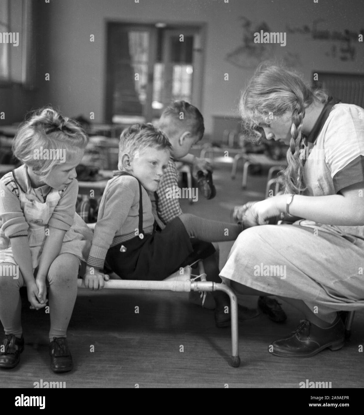 A nursery teacher with her children group at the Kindergarten, Germany ...