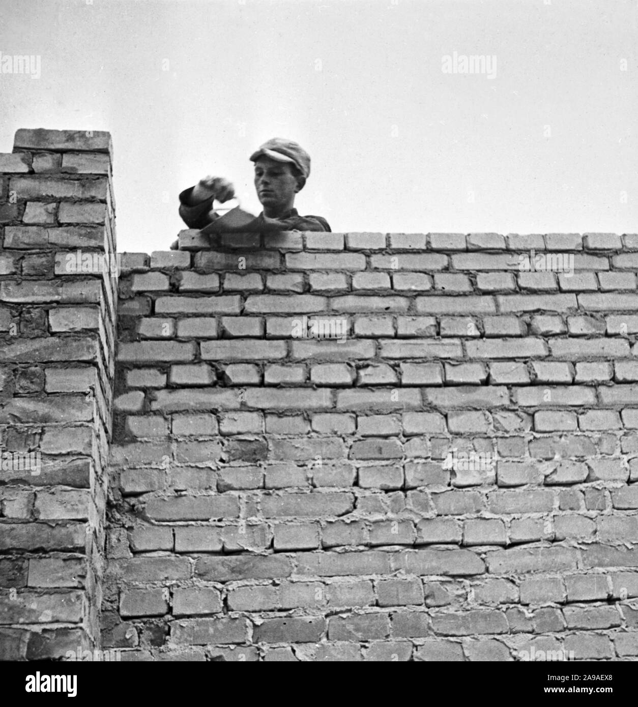 A brick layer doing his job, Germany 1930s Stock Photo - Alamy