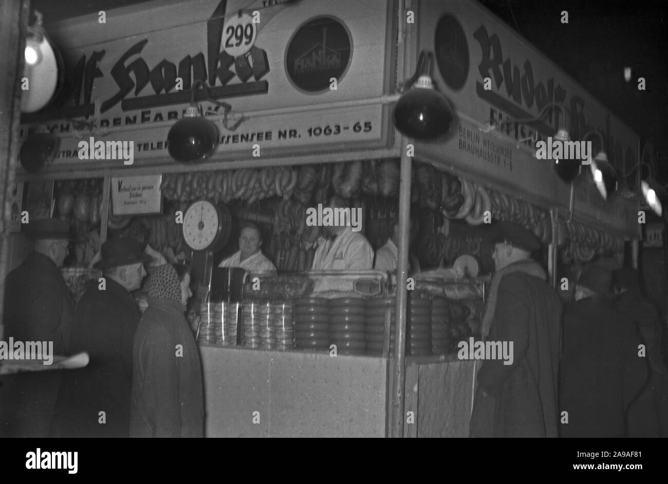 People shopping for food on the market, here Rudolf Hanka's butcher ...