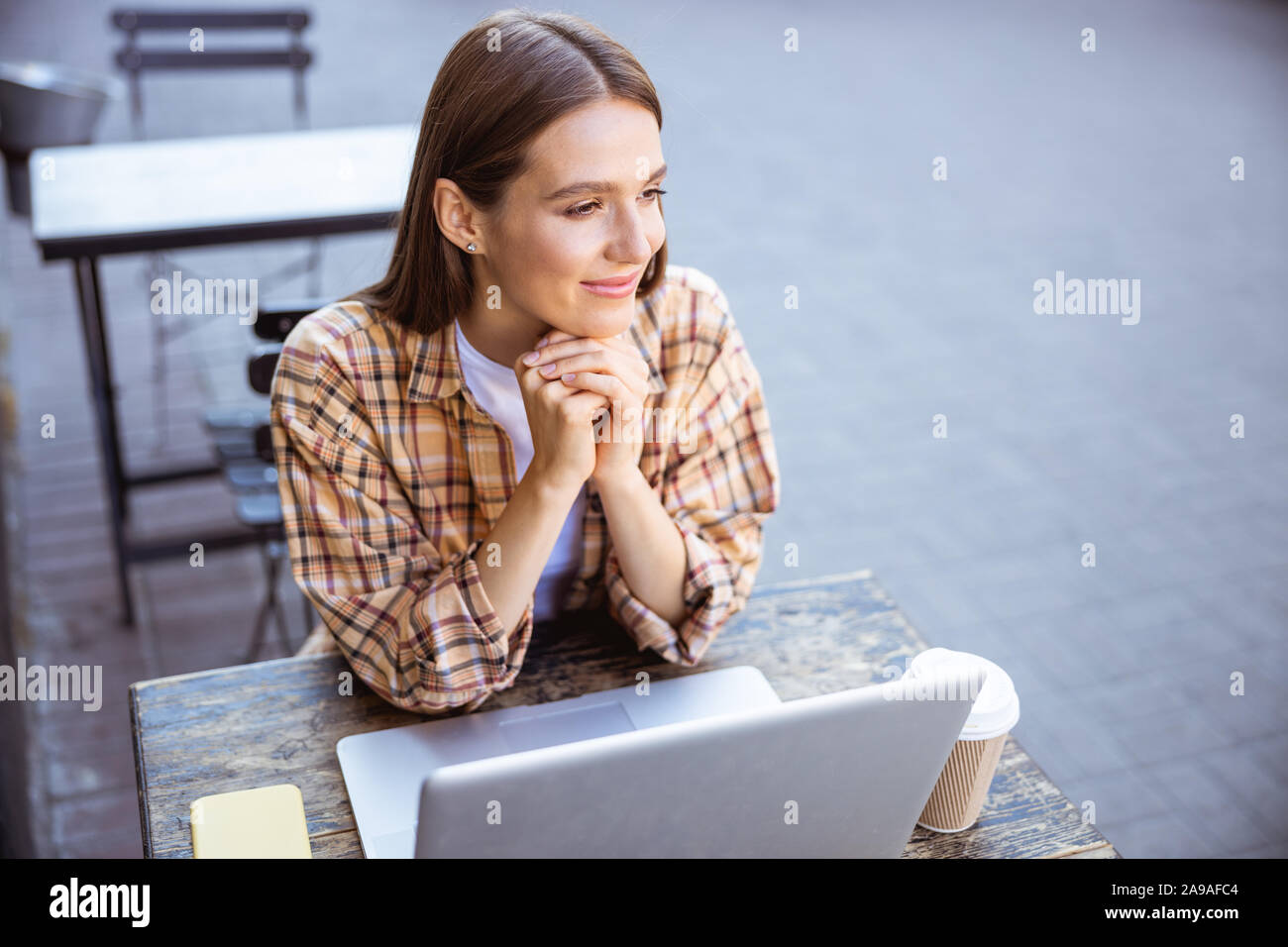 Woman thinking about the reply to her message Stock Photo - Alamy