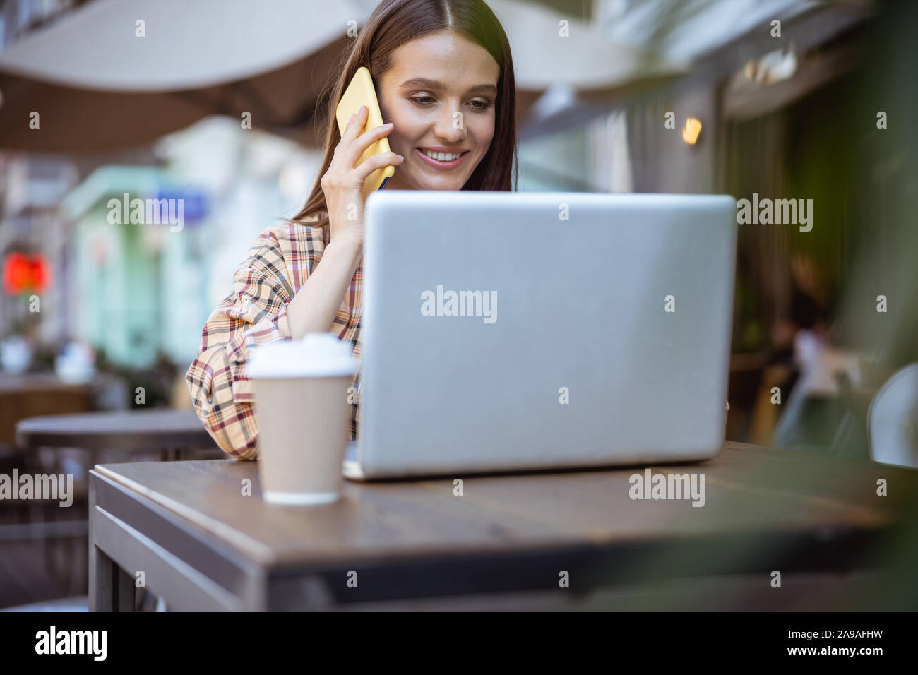 Cheerful lady giving advice to her colleague Stock Photo - Alamy