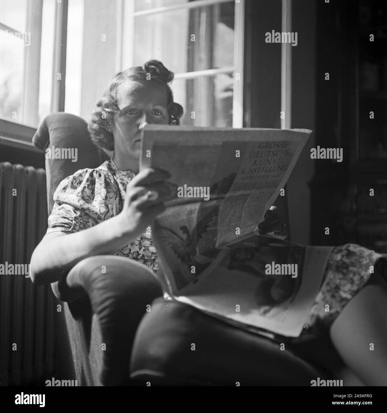 A young woman reading the newspaper, Germany 1940s Stock Photo - Alamy