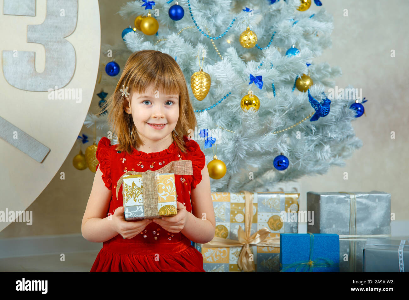 Girl Masha holding a box with a gift and smiling Stock Photo - Alamy